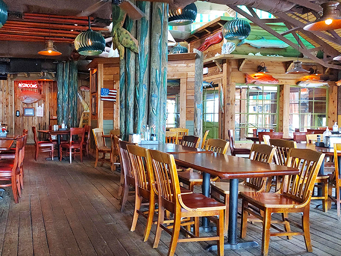Painted tree trunks and wooden chairs create a treehouse-for-adults vibe where seafood consumption is encouraged rather than homework.