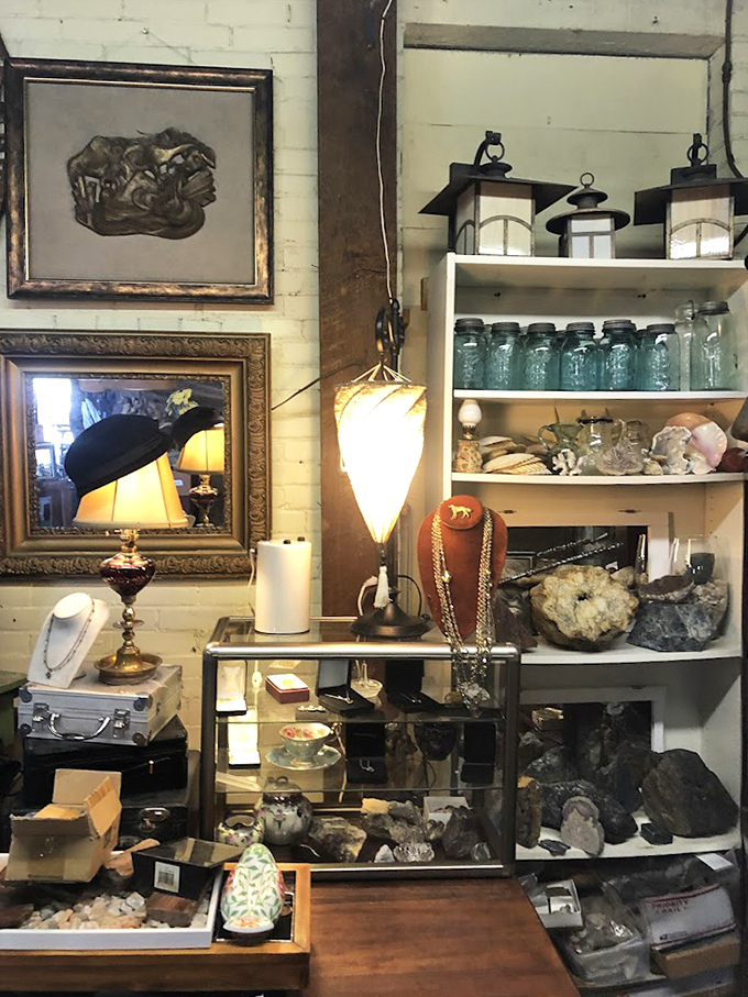 Vintage lamps cast a warm glow over carefully arranged crystals, antique jars, and jewelry—a vignette of treasures within treasures.