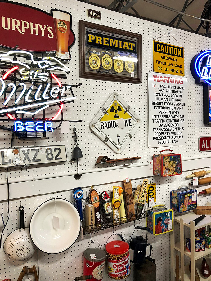 Neon beer signs mingle with vintage lunch boxes and warning placards. Man-cave treasures that transform ordinary walls into conversation starters.