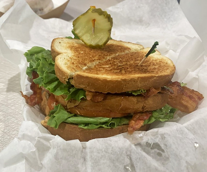 This isn't just a BLT; it's architecture &ndash; layers of crispy bacon, garden-fresh lettuce, and juicy tomato between perfectly toasted bread.