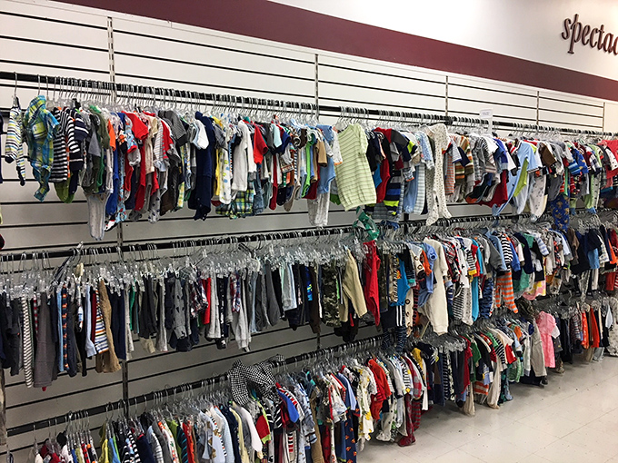 Children's clothes hang in rainbow rows, ready to outfit tiny humans without breaking the bank.