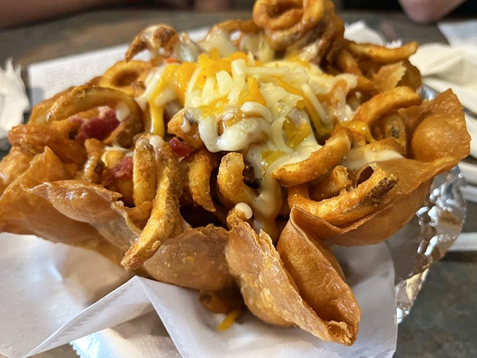 Curly fries wearing a cheesy crown fit for royalty. Calories don't count when they're this artfully arranged.