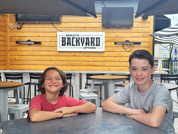 Two young people seem to be enjoying a unique dining experience at The Real Thing's cozy outdoor seating area.