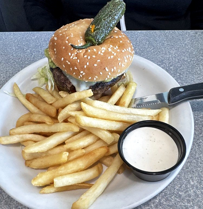 A burger crowned with a pickle scepter, ruling over a kingdom of golden fries. The ranch dressing dipping sauce is the royal treatment your taste buds deserve.