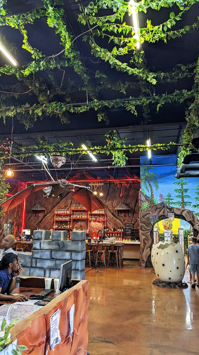 The bar area, where prehistoric meets party time under a canopy of greenery that makes you wonder if velociraptors might be lurking above.