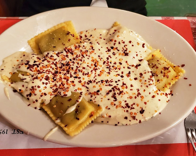 Pillowy ravioli swimming in creamy sauce with red pepper flakes&mdash;proof that pasta and cheese are humanity's greatest collaboration.