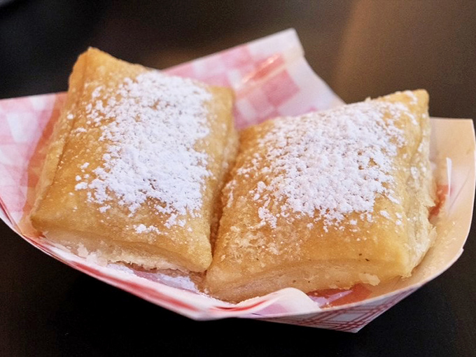 Two golden pillows of fried dough dusted with powdered sugar, waiting to transport you to New Orleans without leaving Michigan.