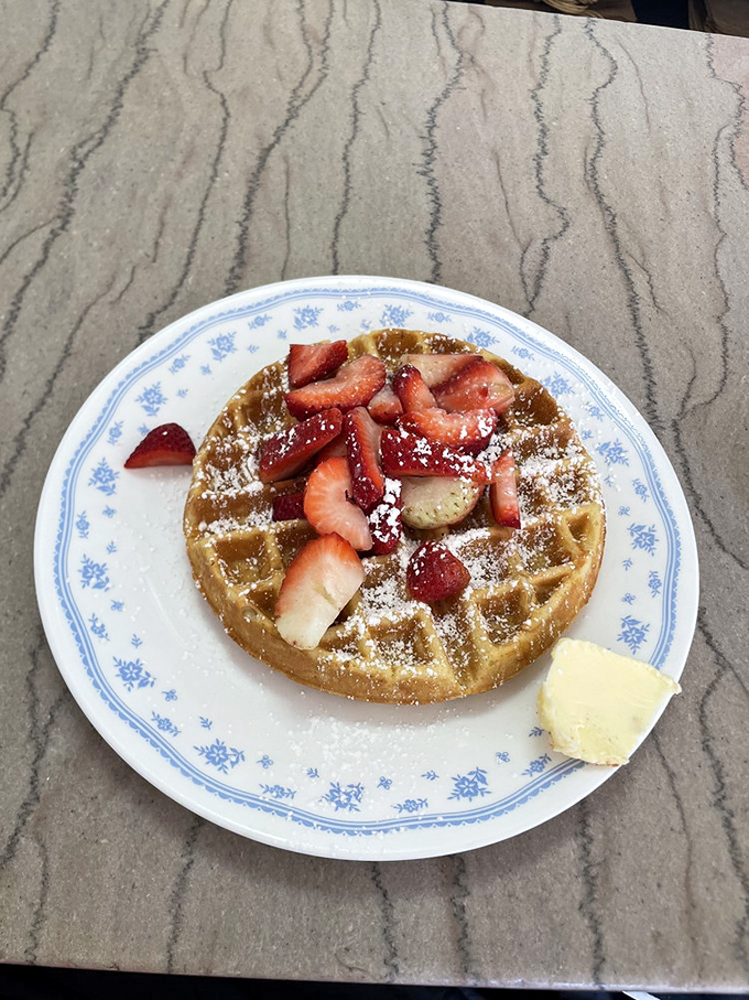 This Belgian waffle topped with fresh strawberries is what breakfast dreams are made of—crisp exterior, tender inside, and fruit that actually tastes like fruit.