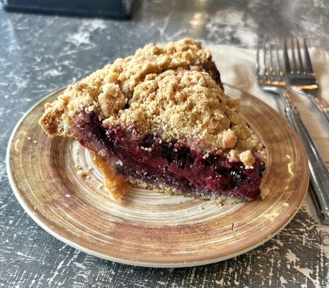 This berry crumble pie with its perfectly golden topping is what fruit dreams of becoming when it grows up. Summer captured in a single slice.