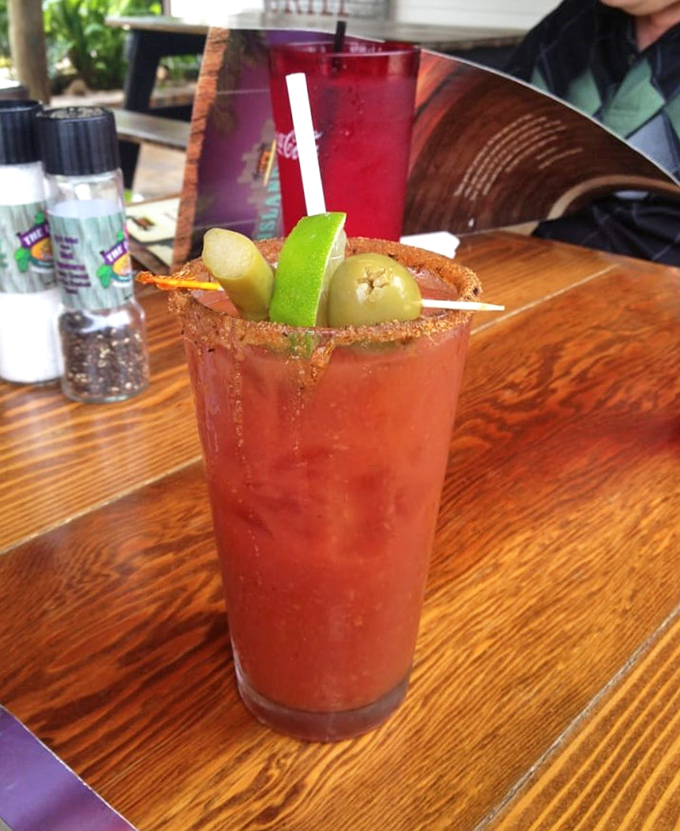 A Bloody Mary garnished like it's trying to upstage the main course. That rim isn't just spiced&mdash;it's an adventure waiting to happen. 