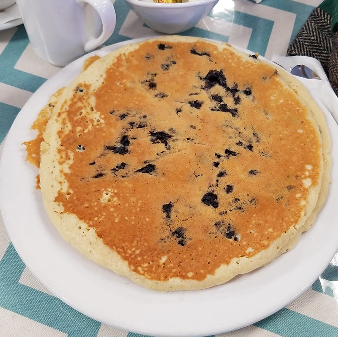Blueberry pancakes so fluffy they practically float, with berries playing hide-and-seek in every delicious bite.