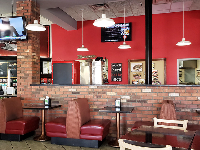 Those red booths aren't just seating&mdash;they're front-row tickets to the comfort food show. The brick wall adds that perfect touch of no-nonsense charm.
