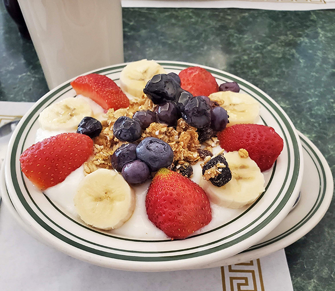 A breakfast masterpiece of yogurt, granola, and fresh fruit &ndash; the kind of healthy choice that makes you feel virtuous enough to order dessert later.
