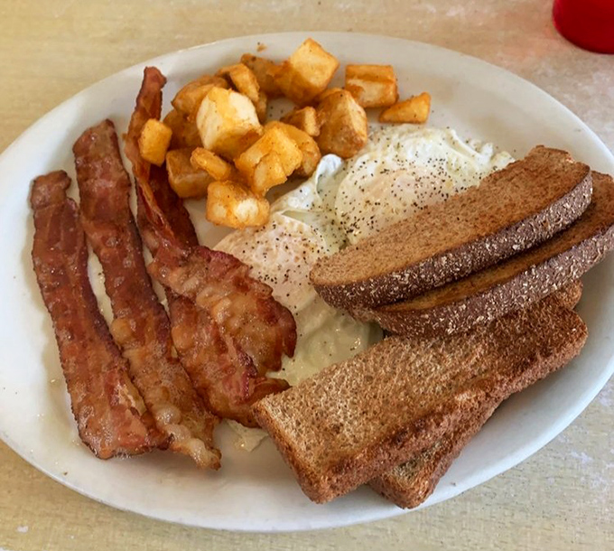 The breakfast trinity &ndash; perfectly cooked eggs, crispy bacon, and golden toast &ndash; proving that sometimes the simplest combinations are the most satisfying.