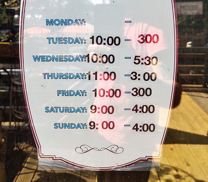 Hours posted like they've been there forever, probably typed on that Remington inside the store.