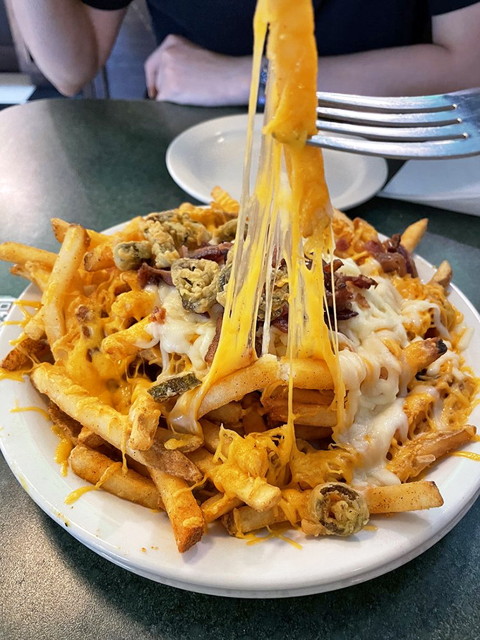 Cheese fries that don't just flirt with decadence&mdash;they're in a committed relationship with it. That cheese pull deserves its own slow-motion sequence.