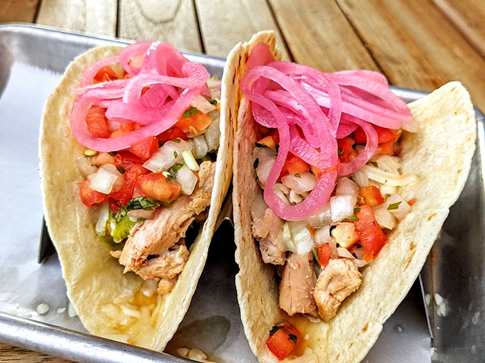 These tacos don't need Tuesday as an excuse—tender smoked chicken, bright pico, and those signature pink onions create everyday celebration food.