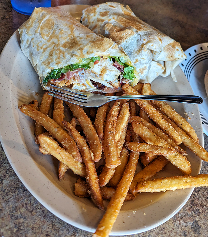 This wrap isn't messing around&mdash;packed tight with goodness and grilled to perfection. Those seasoned fries deserve their own fan club.
