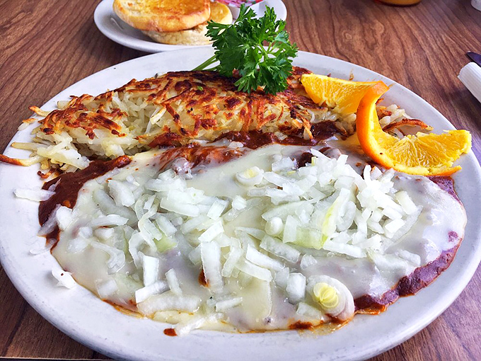 This isn't just an omelet&mdash;it's a celebration with hash browns and fresh orange slices. The crispy edges of those potatoes are what breakfast fantasies are made of.