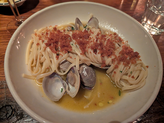 Linguine with clams swimming in a buttery broth that begs to be sopped up with bread. The pasta speaks fluent Italian; your taste buds will understand.