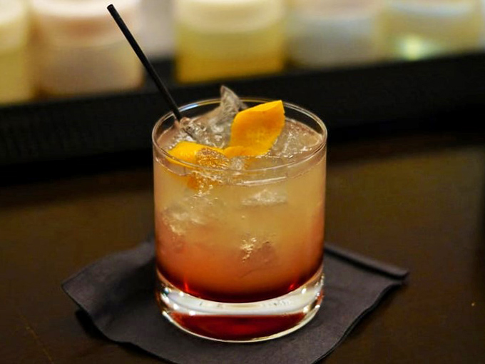 A cocktail that glows like a Florida sunset, garnished with citrus and promising refreshment that's both sophisticated and playful.