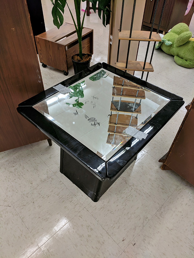 This vintage glass coffee table whispers of 1980s sophistication, just waiting for its retro charm to anchor someone's living room.