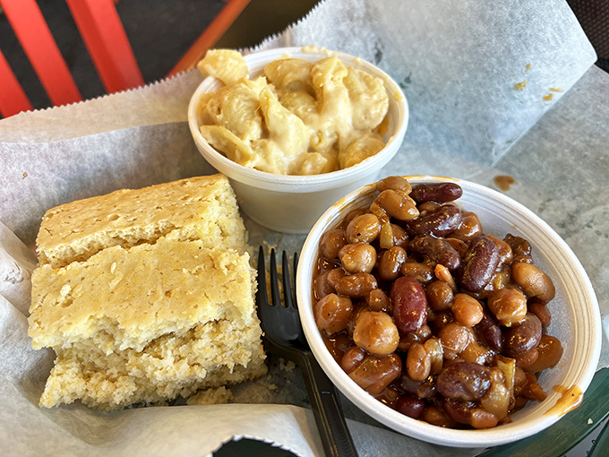 Cornbread that crumbles just right, mac and cheese that hugs every fork tine, and beans that have clearly been simmering alongside barbecue royalty.