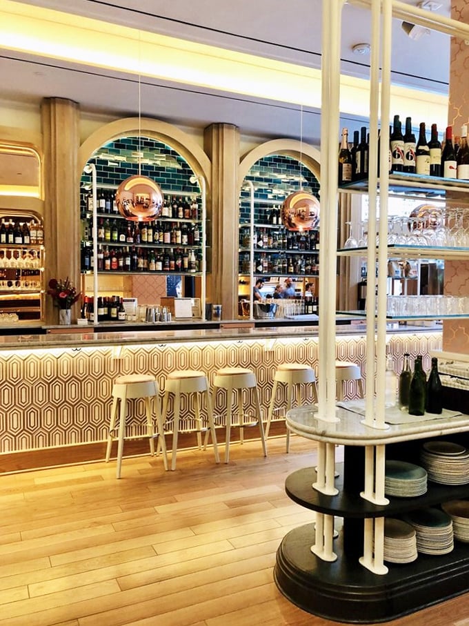 The bar area's warm wood tones and geometric patterns create a space that feels both retro and thoroughly modern&mdash;like stepping into a design magazine that serves amazing food.