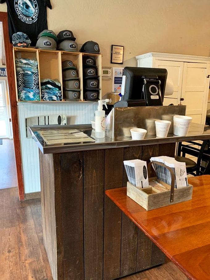 The counter where chowder dreams begin. Those stacked merchandise items let you take a piece of coastal comfort home.