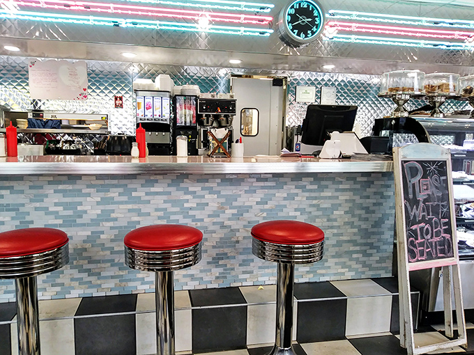 The counter's blue tile work and cherry-red stools create the perfect stage for that most sacred of American rituals: the diner breakfast.