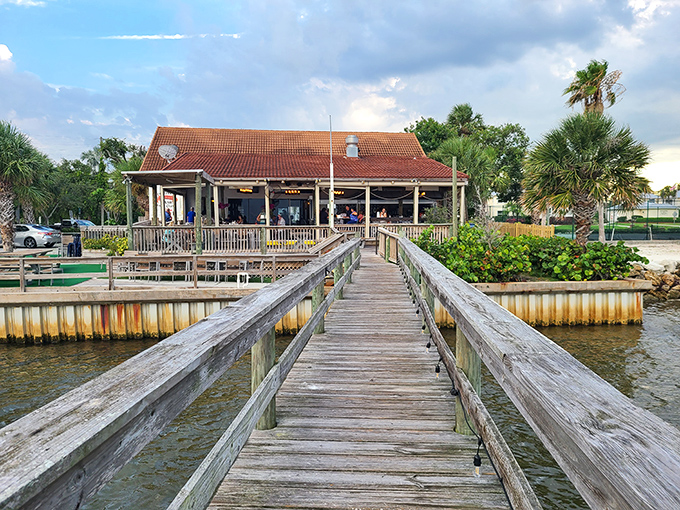 The Crab Stop's weathered dock invites you to a seafood pilgrimage where the journey across wooden planks builds anticipation for the feast that awaits.