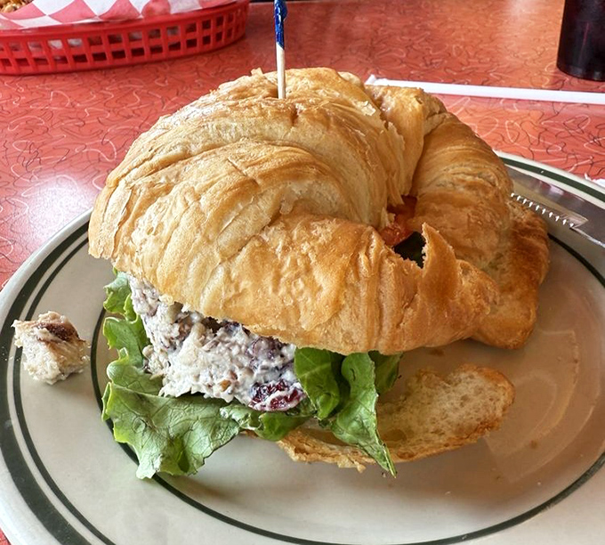 The chicken salad croissant arrives like a flaky cloud cradling its savory contents, proof that simple sandwiches can still inspire poetry.