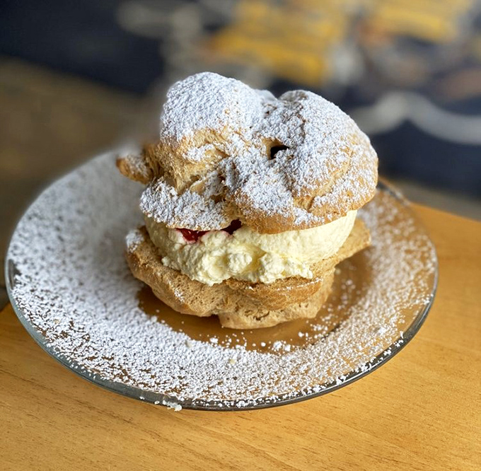 A cream puff that deserves its own Instagram account. Dusted with powdered sugar like fresh snow, it's the sweet finale your meal deserves.