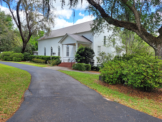 This white chapel nestled among Spanish moss-draped oaks embodies the quiet dignity that makes small-town architecture so timelessly appealing.