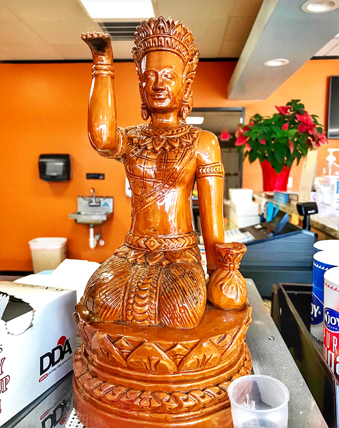 This wooden statue stands guard over the donut kingdom, raising its arm as if to say, "Yes, you absolutely should get the chocolate glaze."