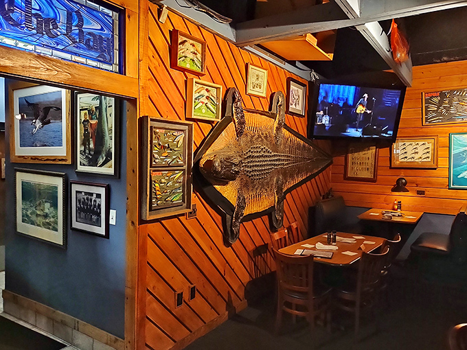 Mounted fish watching over diners like aquatic guardians of good taste. The wood paneling practically radiates warmth.