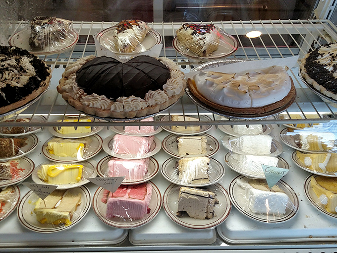 The dessert case—where willpower goes to die. Each slice of pie and cake patiently waits its turn to ruin your diet in the most delicious way.