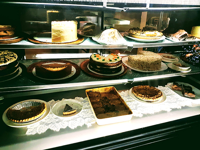 The dessert case&mdash;where willpower goes to die a glorious, sweet death. Each cake and pie represents a different path to happiness, all equally valid.