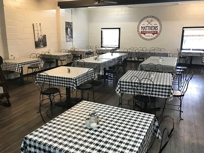 The dining room waits patiently between rushes, checkered tablecloths standing at attention. These tables have stories to tell.