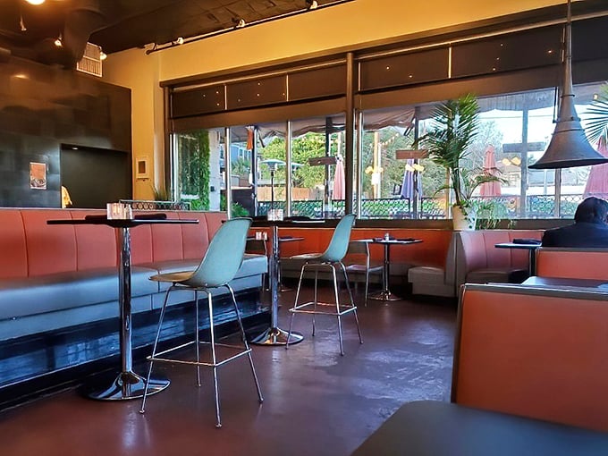 Coral booths and mint-green walls create a retro-modern vibe that feels both nostalgic and completely current.