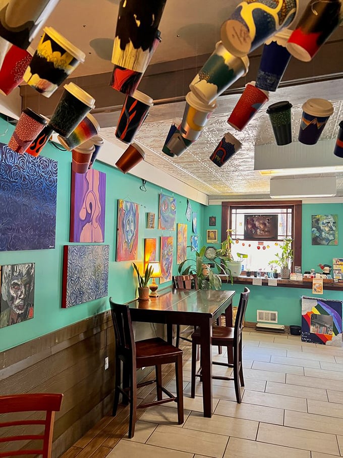 The eclectic dining area where paintbrushes dance overhead and conversations flow as smoothly as coffee.