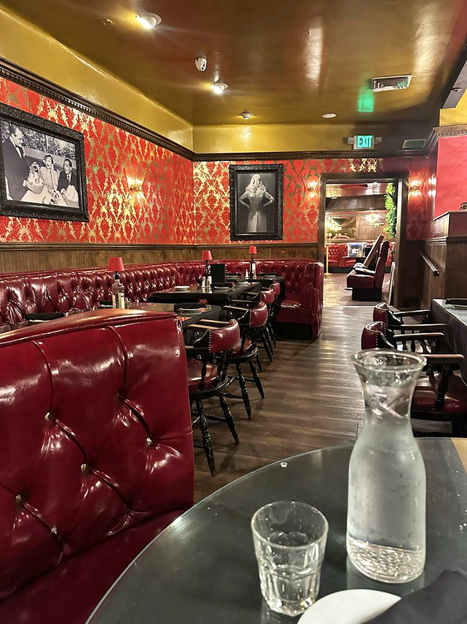 Red damask wallpaper and tufted booths&mdash;where conversations flow as smoothly as the wine. Marilyn Monroe keeps a watchful eye.