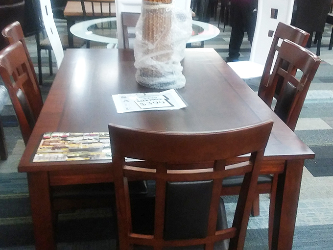 Dining sets await new homes and fresh dinner conversations. This solid wood table has probably hosted thousands of meals in its previous life.