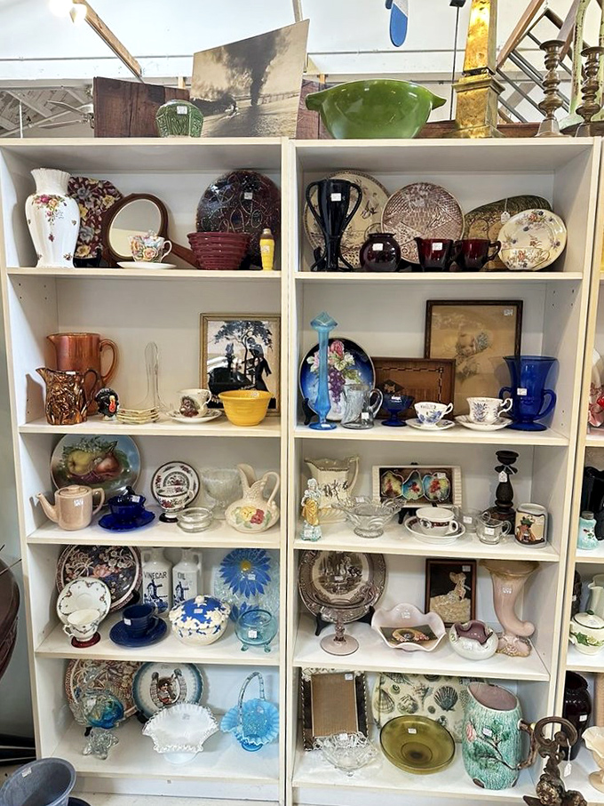 Shelves of vintage dishware tell stories of dinner parties past, where floral patterns and cobalt blue pieces wait to grace new tables.