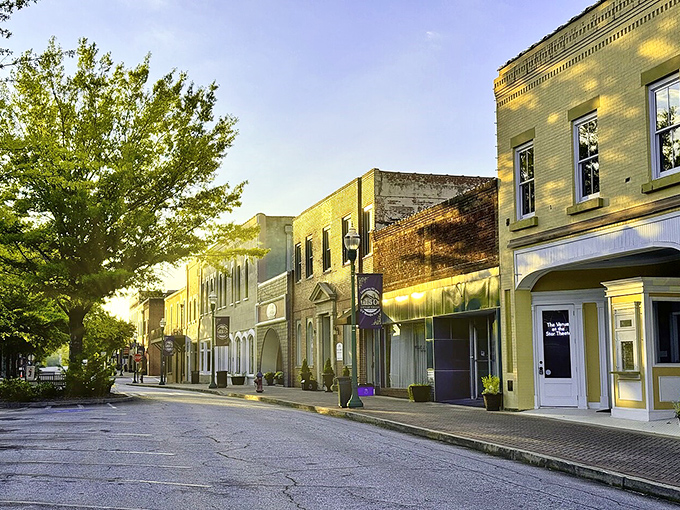 Downtown Toccoa glows golden in late afternoon light, transforming ordinary storefronts into a Norman Rockwell painting come to life.