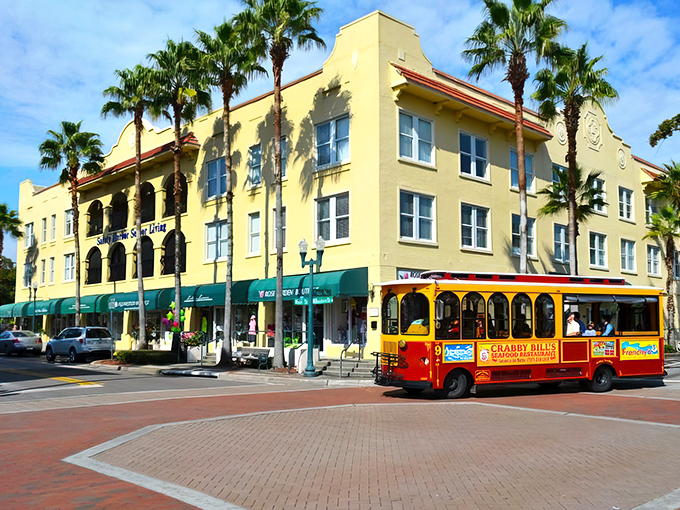The historic Safety Harbor Resort stands proudly alongside a cheerful trolley. Where old-world elegance meets small-town transportation charm.