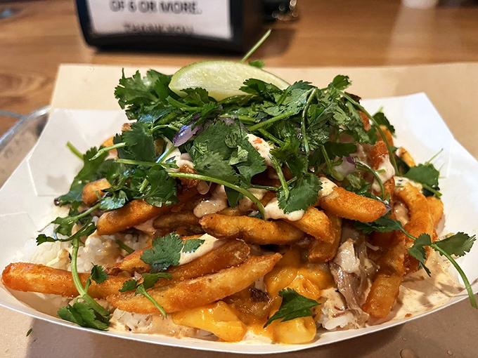 French fries playing dress-up in their Sunday best&mdash;topped with pulled pork and drizzled with sauce that makes ketchup seem like a sad afterthought.