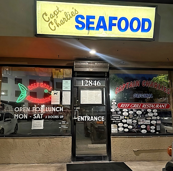The neon glow of Captain Charlie's sign serves as a lighthouse for hungry souls seeking authentic seafood treasures.