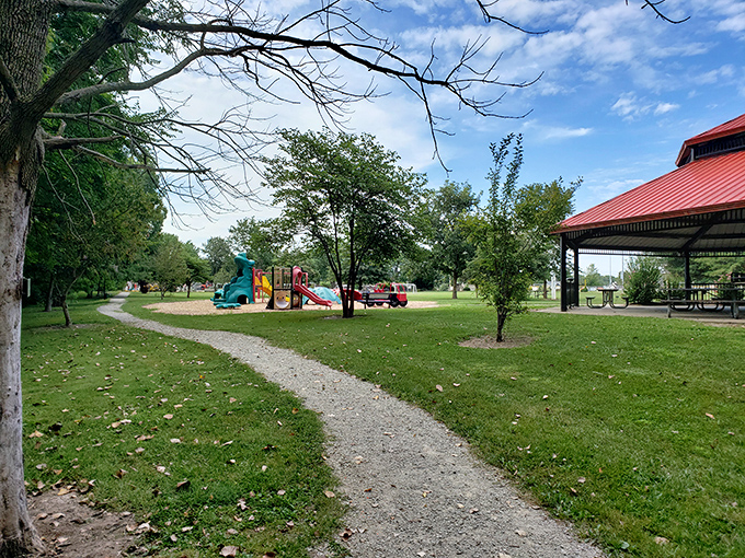 Evergreen Hollow Park's winding path invites leisurely strolls where the only decision more pressing than which trail to take is which bench to rest on.