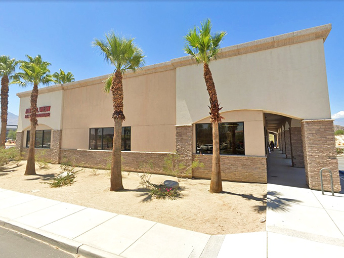 Desert architecture at its most practical—stucco walls and stone accents keeping the treasures inside cool while the Palm Springs sun blazes outside.